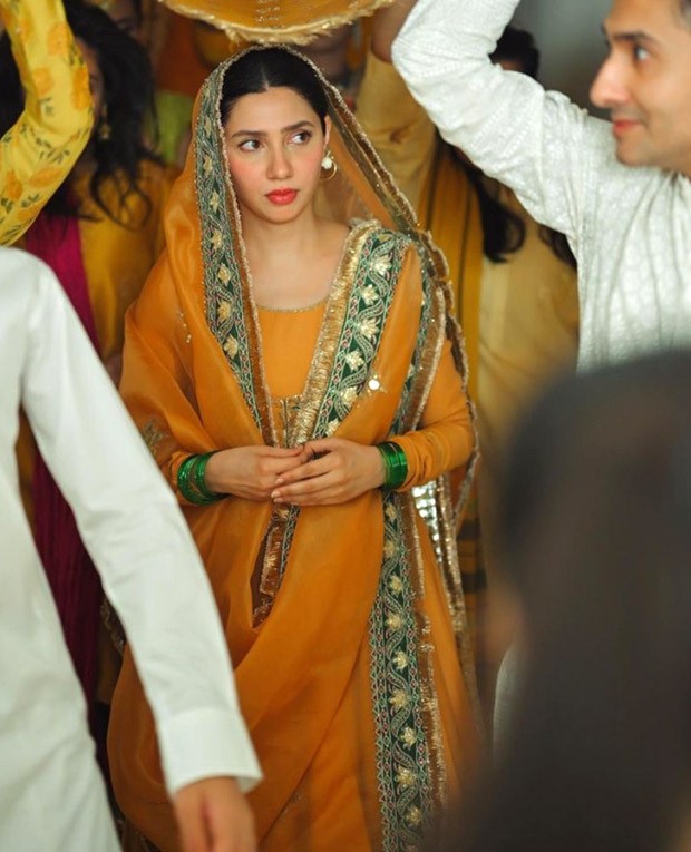 Mahira Khan beams with joy during her Mayoon ceremony, adorned in a vibrant orange Anarkali ...